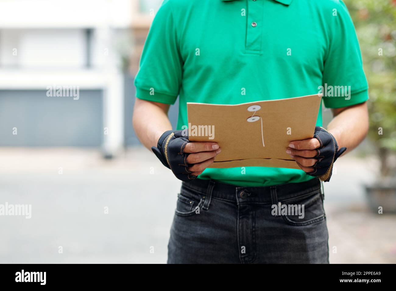 Courier delivering envelope with important document Stock Photo - Alamy