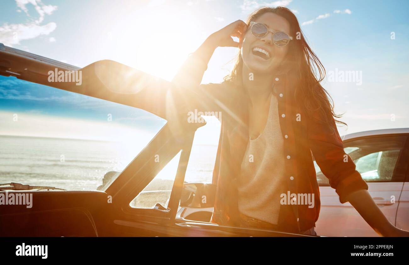 The road tripping life is the best life. a happy young woman enjoying a ...