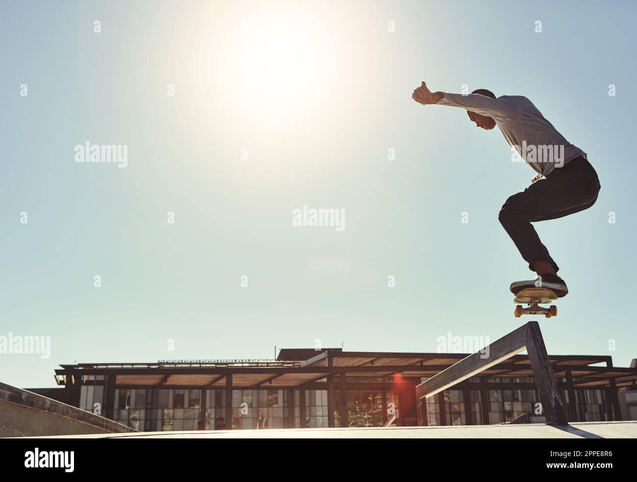 Grinding it out at the park. Full length shot of a young man doing ...
