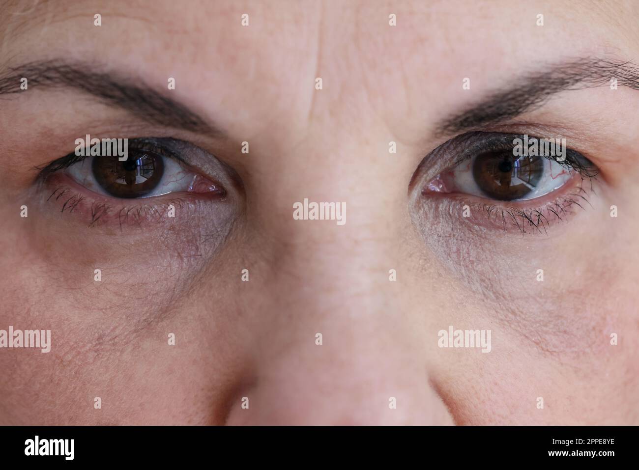 Senior woman face with dark brown eyes and wrinkles Stock Photo - Alamy