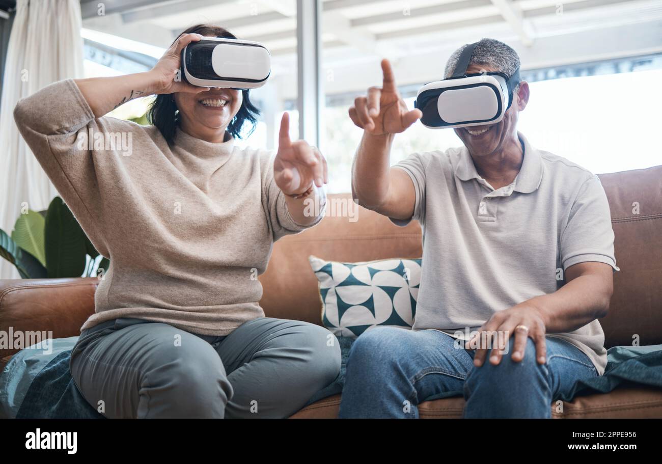 Senior couple, virtual reality and sofa in home living room with ...