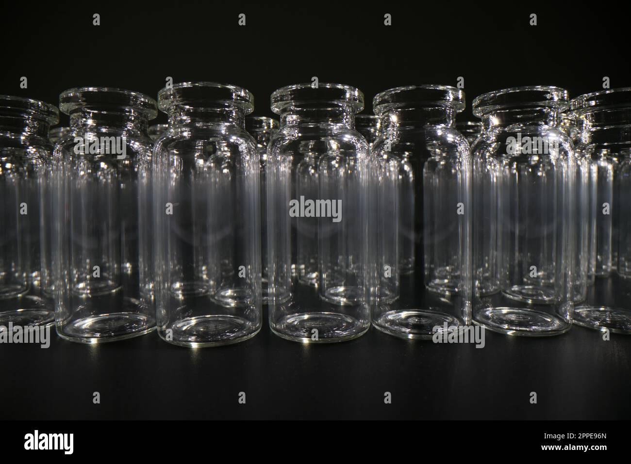 Empty vials for vaccines stand in row on dark background Stock Photo ...