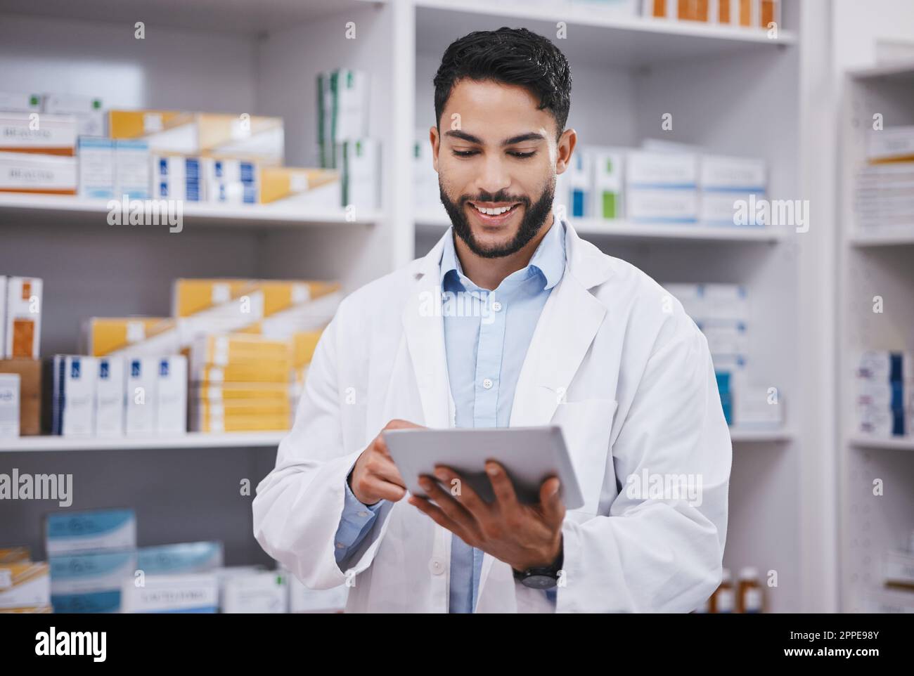 Pharmacy, happy man or pharmacist reading on tablet for research or ...