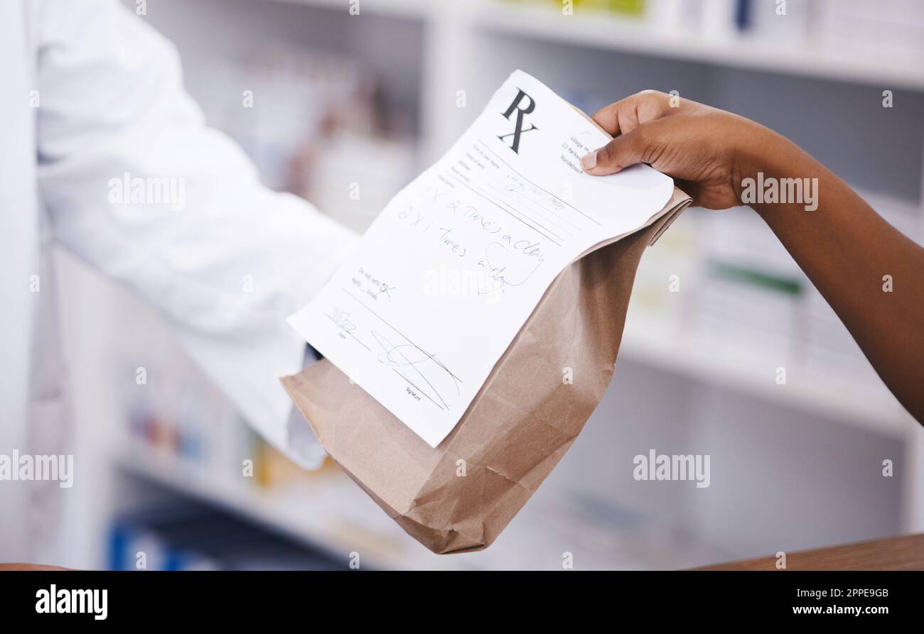 Retail, medicine or pharmacist hands a person a bag in drugstore with ...