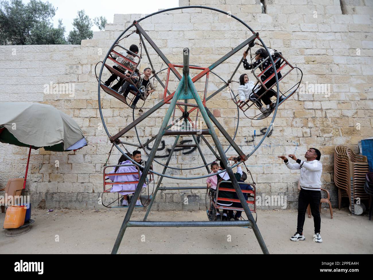 Gaza, Palestine. 23rd Apr, 2023. Palestinian children ride on Ferris ...