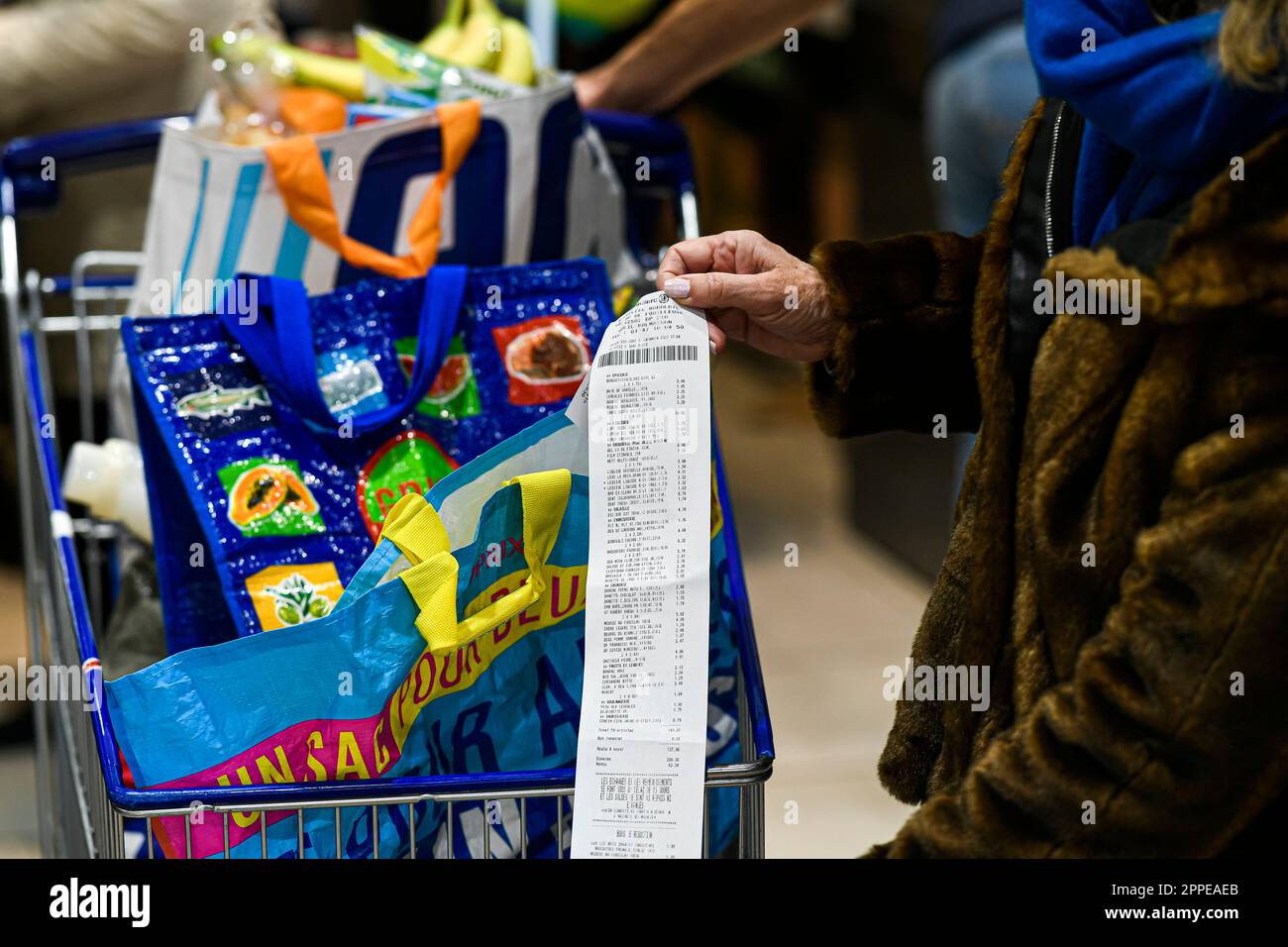 Illustration shows a customer checking his cashier's paper receipt as ...