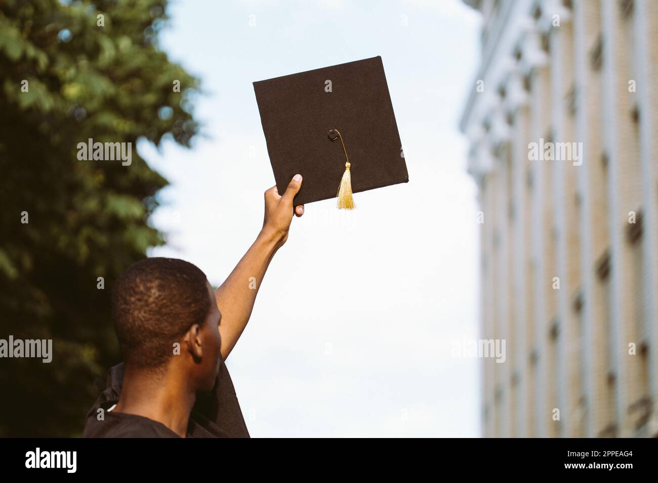 Photo back view of african american graduate from university standing ...