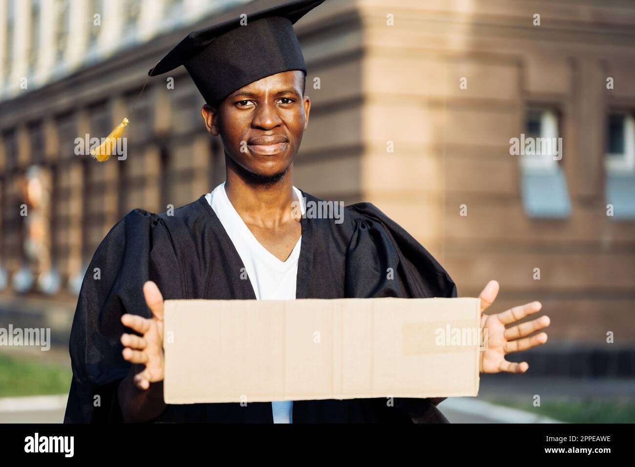 Poor black guy standing with cardboard sign on street looking for job ...