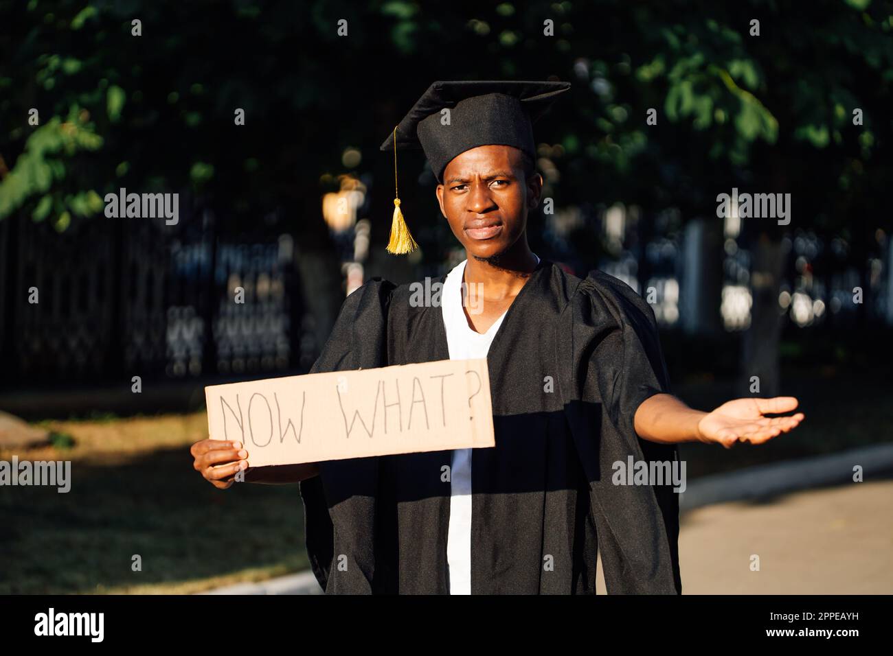 Sad college graduate holding diploma hi-res stock photography and ...