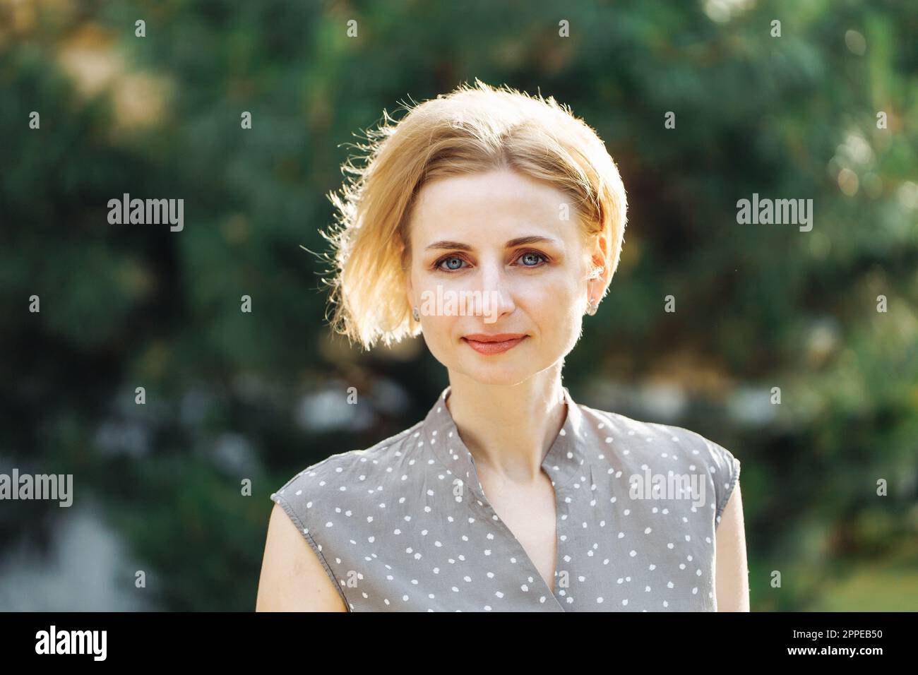 Portrait closeup of attractive looking woman standing half turn ...