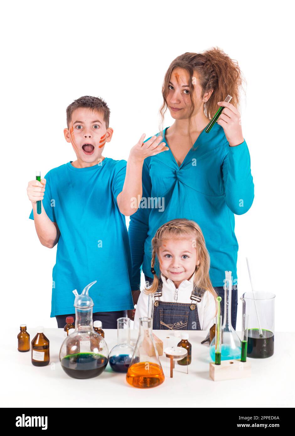 Three children working with chemical liquids at lesson Crazy scientist ...