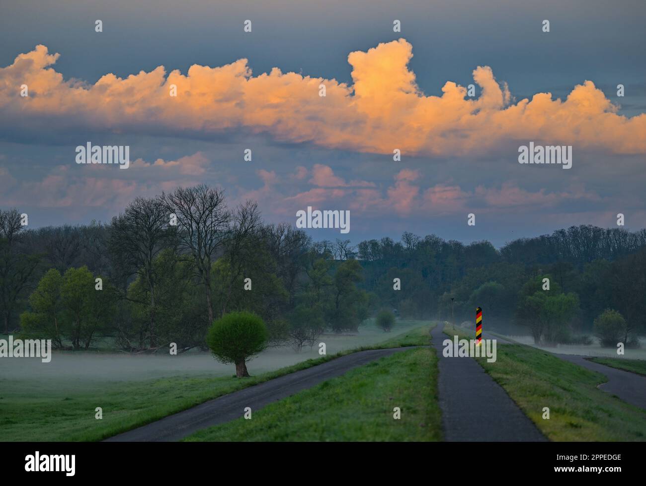 Lebus, Germany. 24th Apr, 2023. The sunrise shines on clouds above the ...