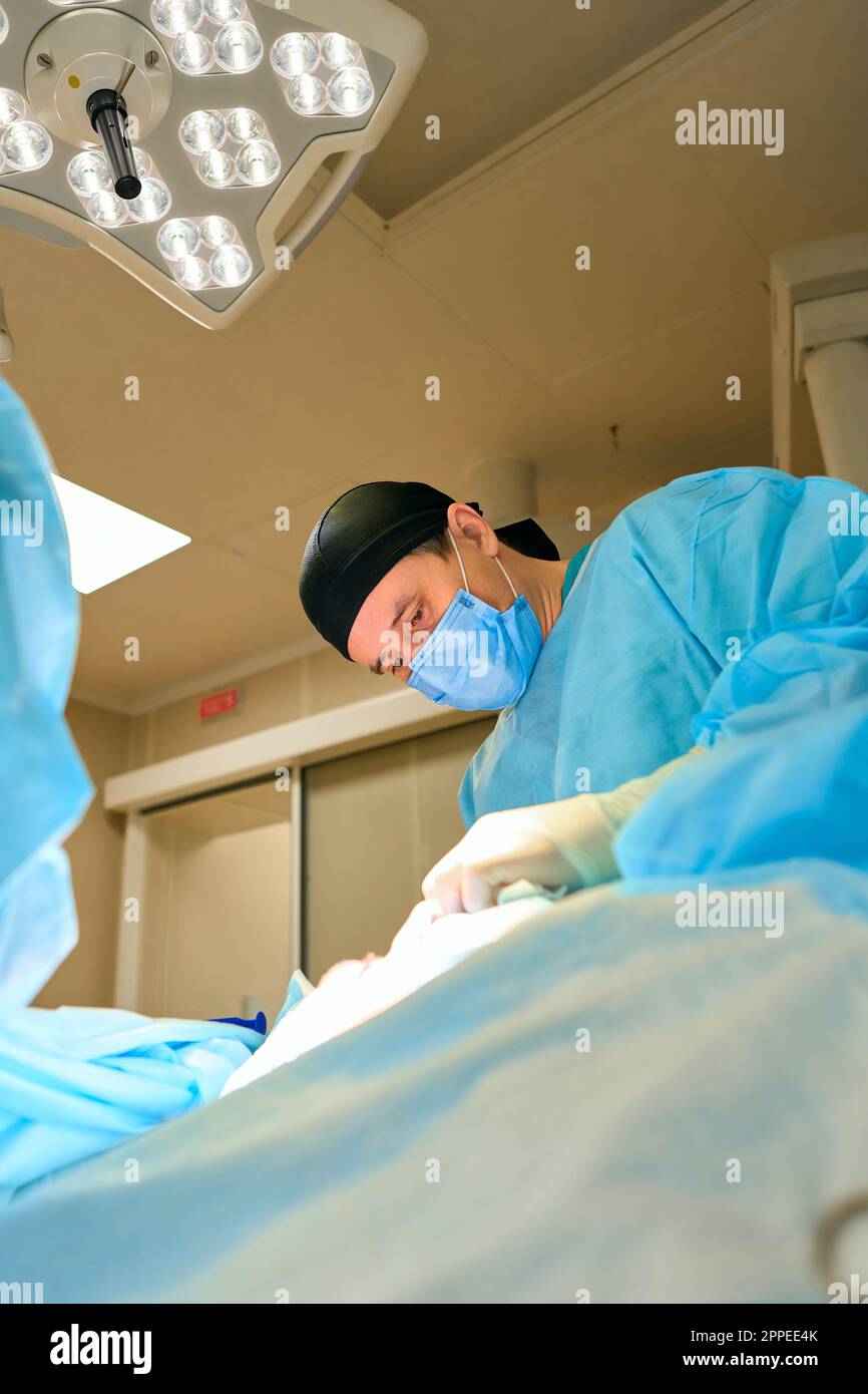 plastic surgeon operates on a patient in the operating room Stock Photo ...