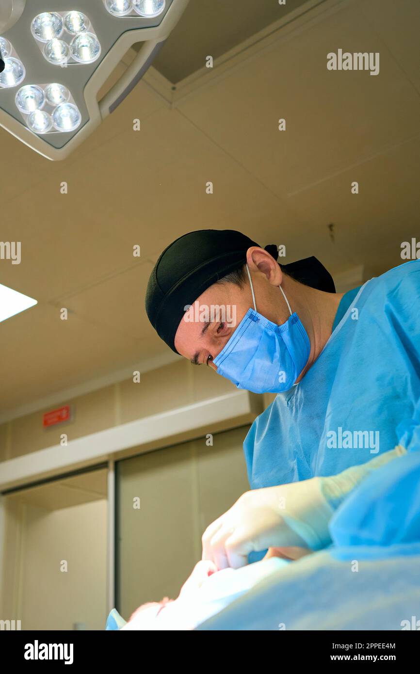 plastic surgeon operates on a patient in the operating room Stock Photo ...