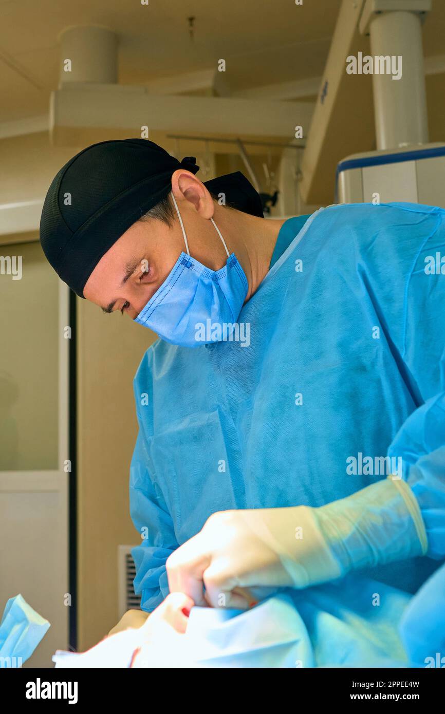 plastic surgeon operates on a patient in the operating room Stock Photo ...