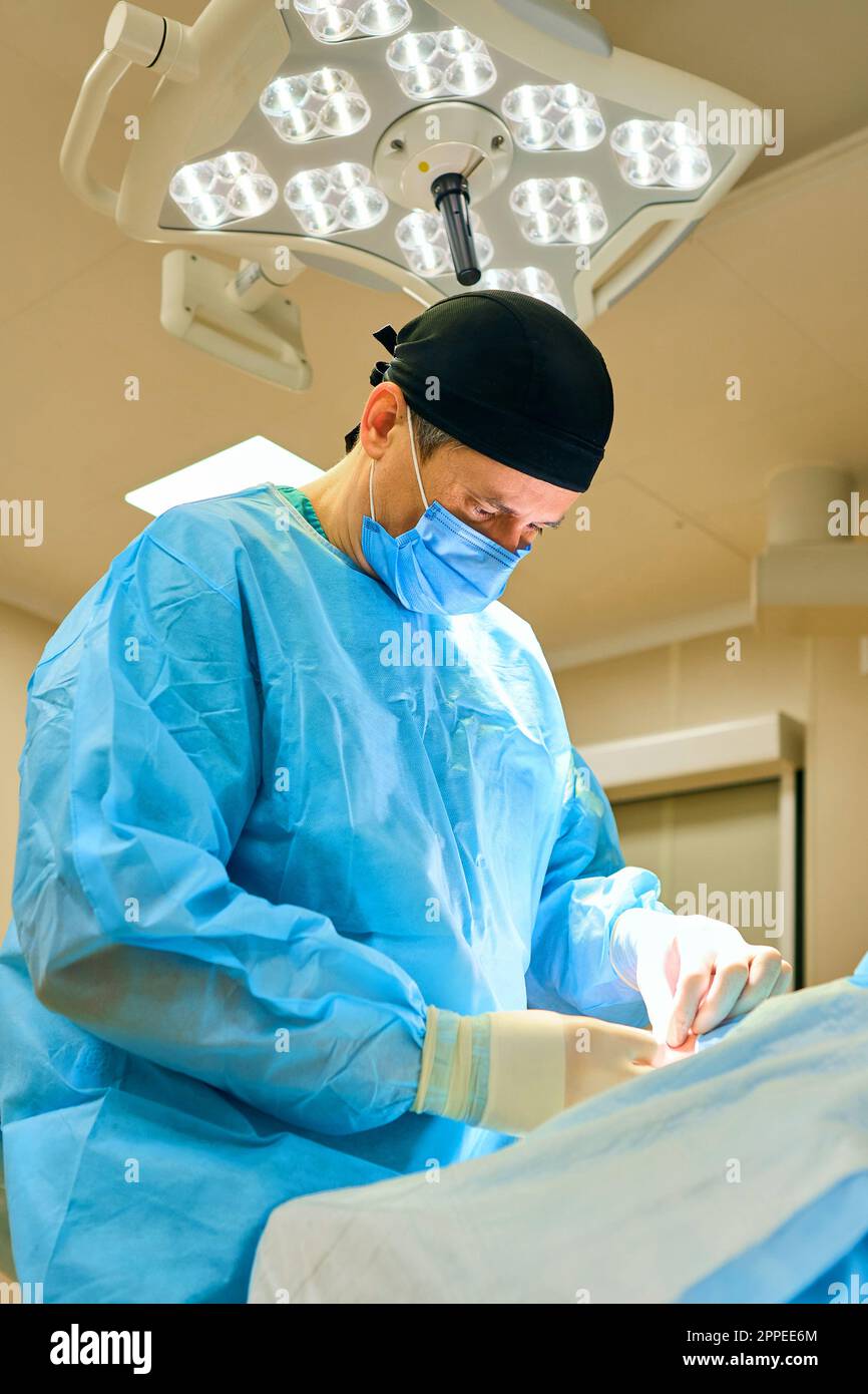plastic surgeon operates on a patient in the operating room Stock Photo ...