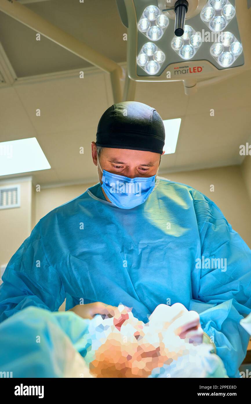 plastic surgeon operates on a patient in the operating room Stock Photo ...