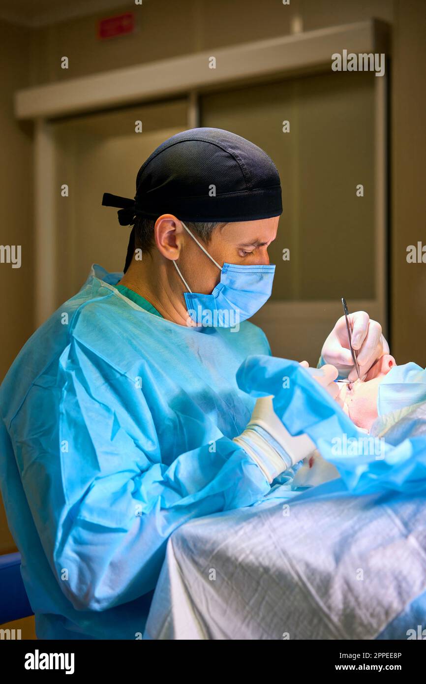 plastic surgeon operates on a patient in the operating room Stock Photo ...