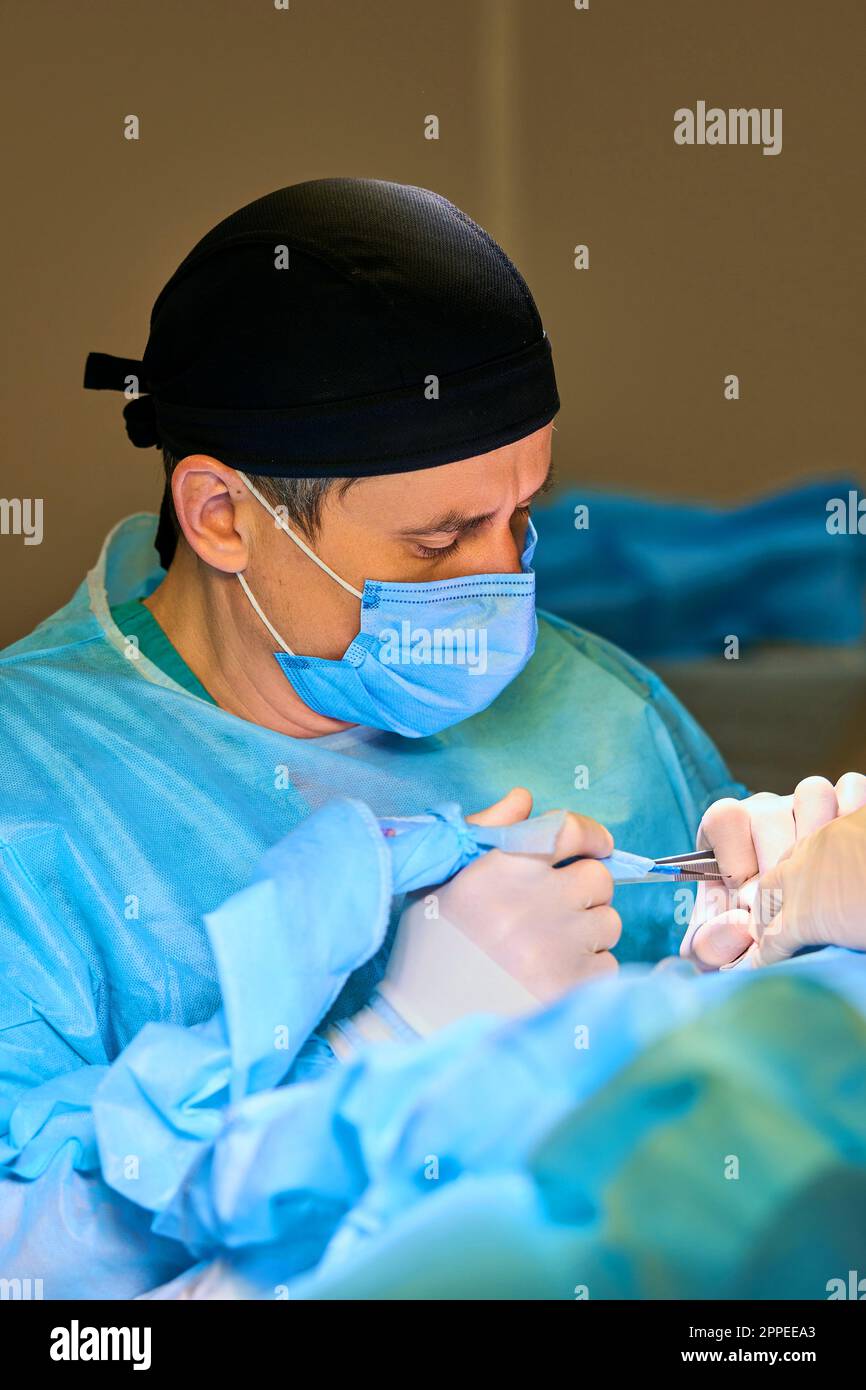 plastic surgeon operates on a patient in the operating room Stock Photo ...