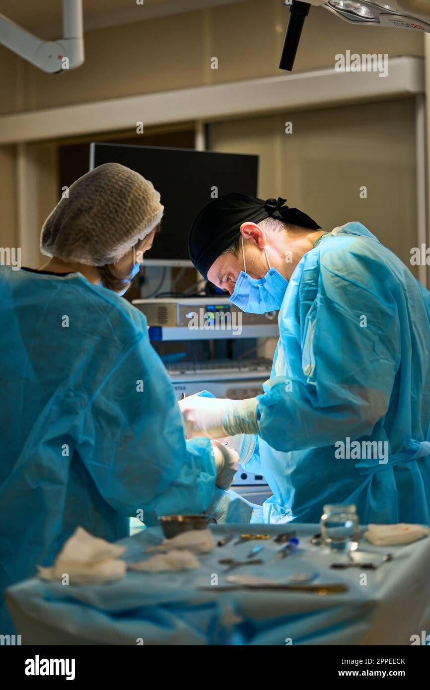 plastic surgeon operates on a patient in the operating room Stock Photo ...