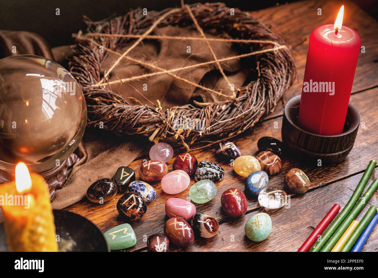 Runestones on red napkin. Divination items. Runes, crystal ball ...