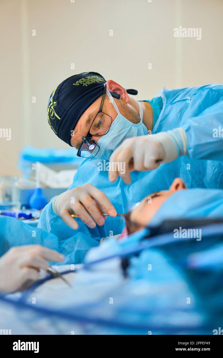 plastic surgeon operates on a patient in the operating room Stock Photo ...