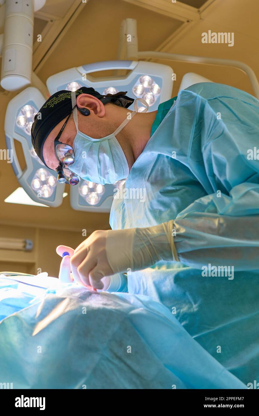 plastic surgeon operates on a patient in the operating room Stock Photo ...