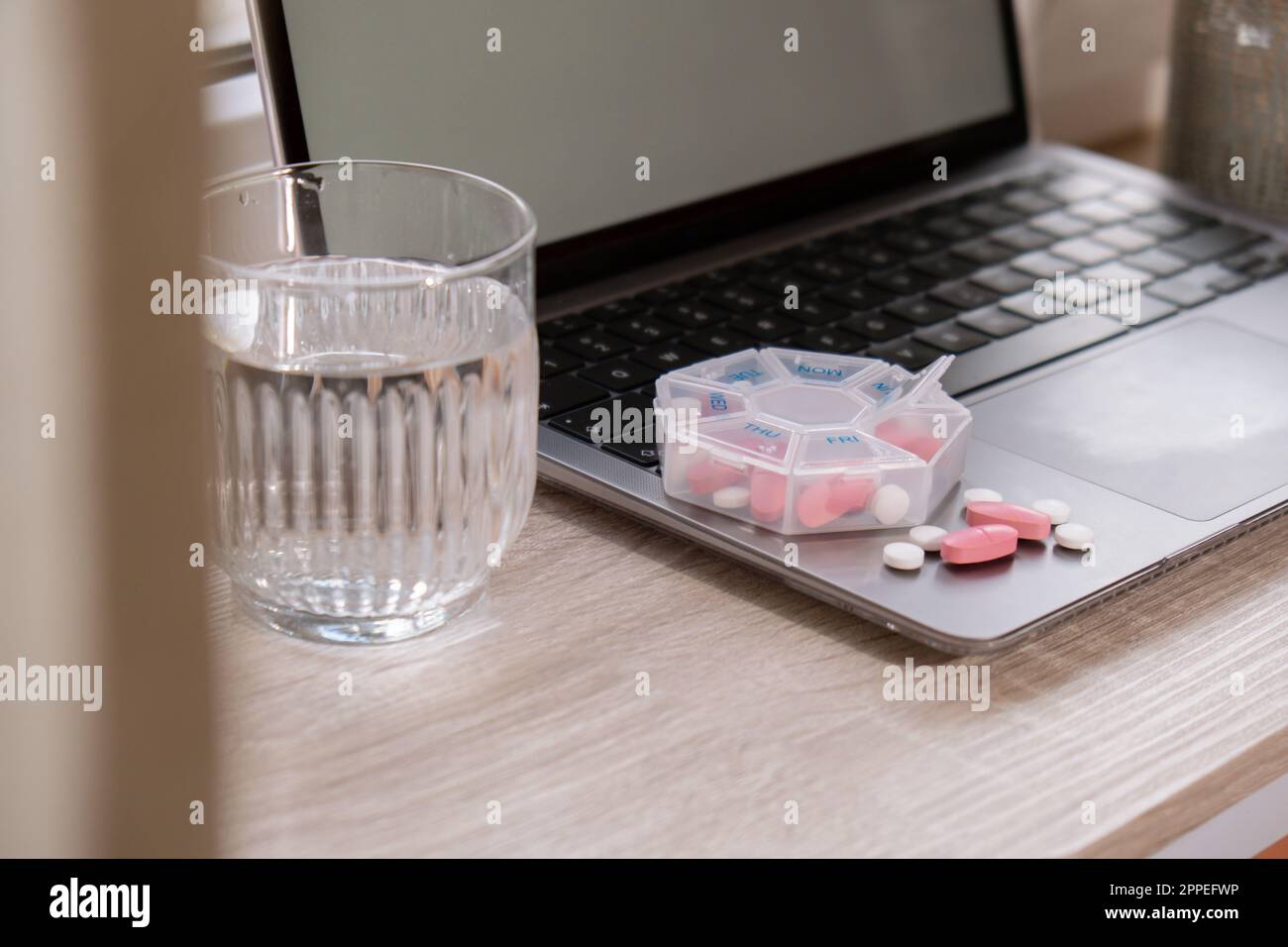 Organizer weekly shots with glass of water on workplace background and ...