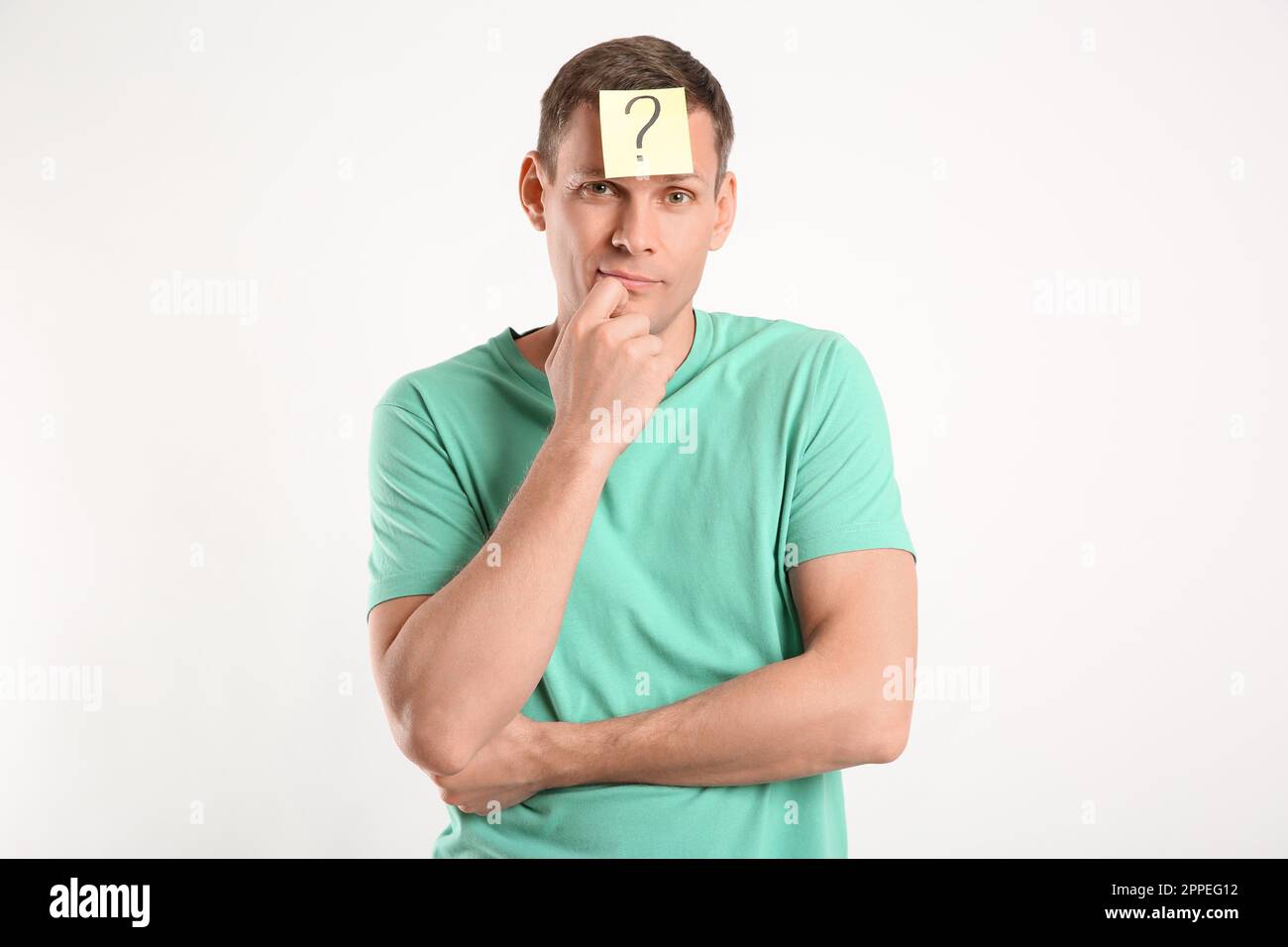 Thoughtful man with question mark on white background Stock Photo - Alamy
