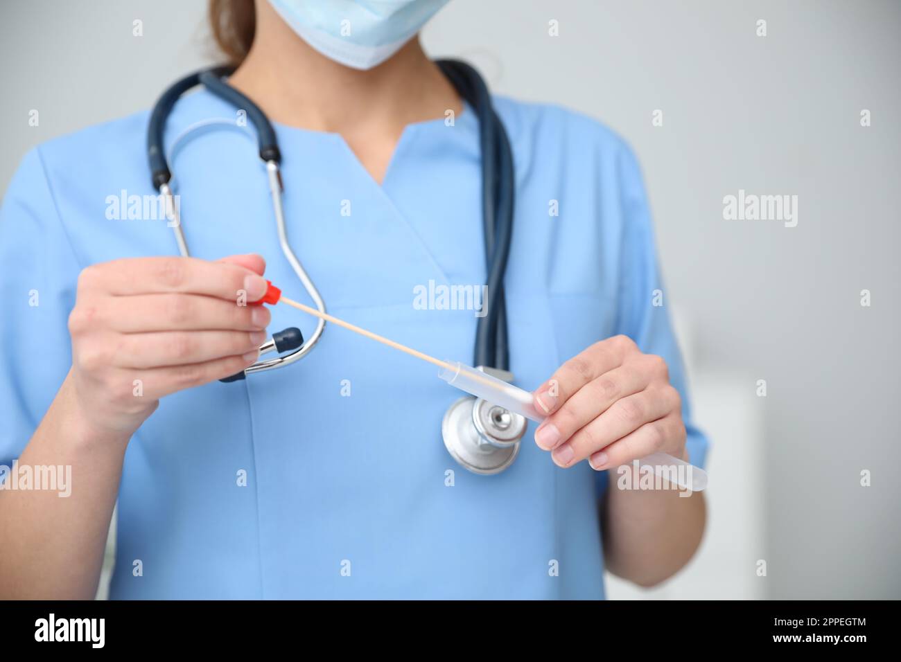 Doctor holding buccal cotton swab and tube for DNA test in clinic ...