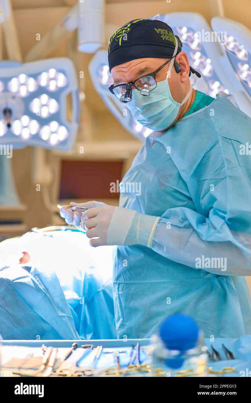 plastic surgeon operates on a patient in the operating room Stock Photo ...
