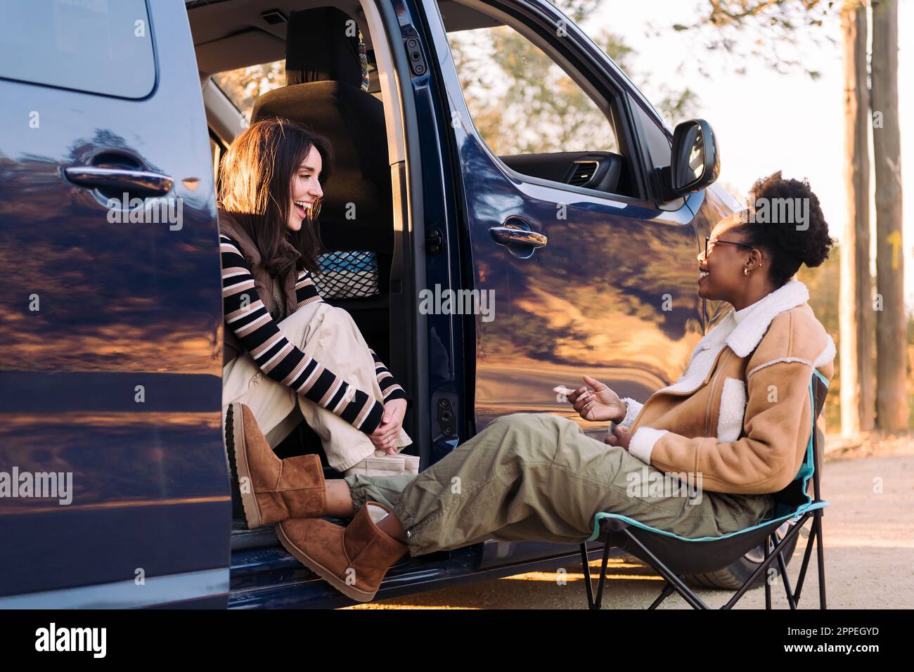 two young friends chatting happy in camper van Stock Photo - Alamy