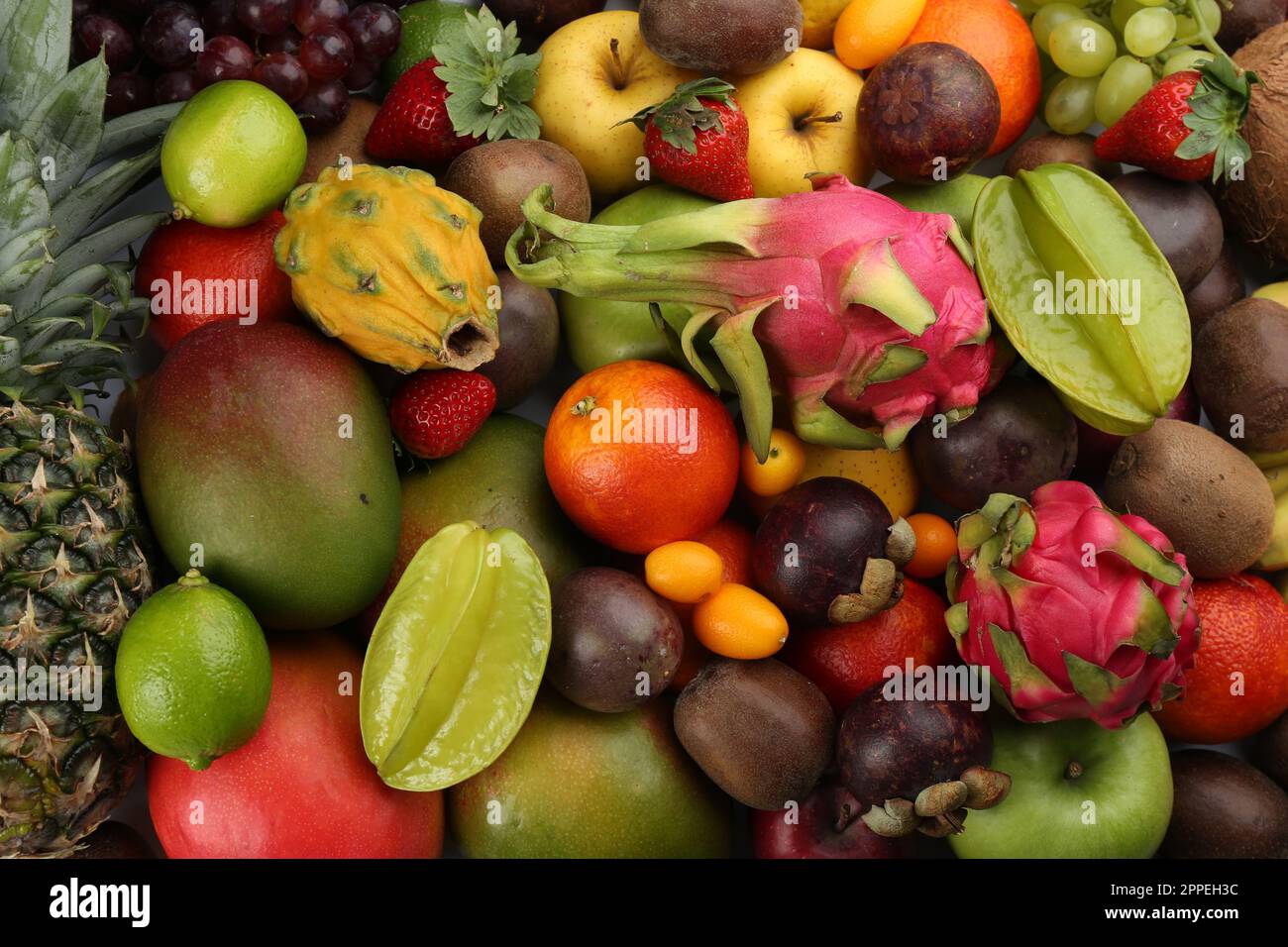 Assortment of fresh exotic fruits as background, top view Stock Photo ...