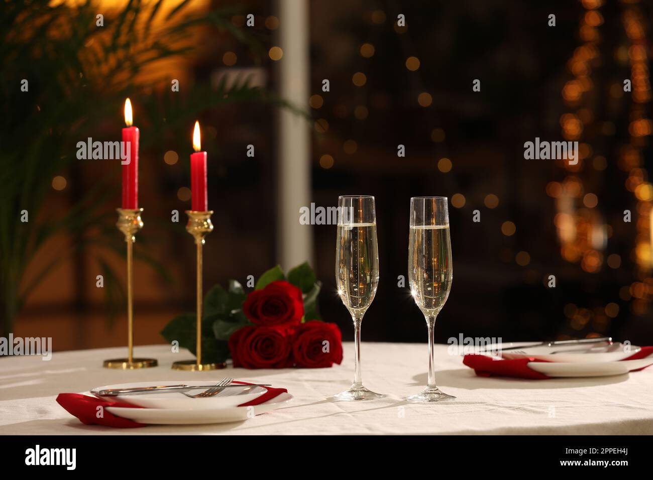 Romantic dinner table setting with glasses of champagne in restaurant ...