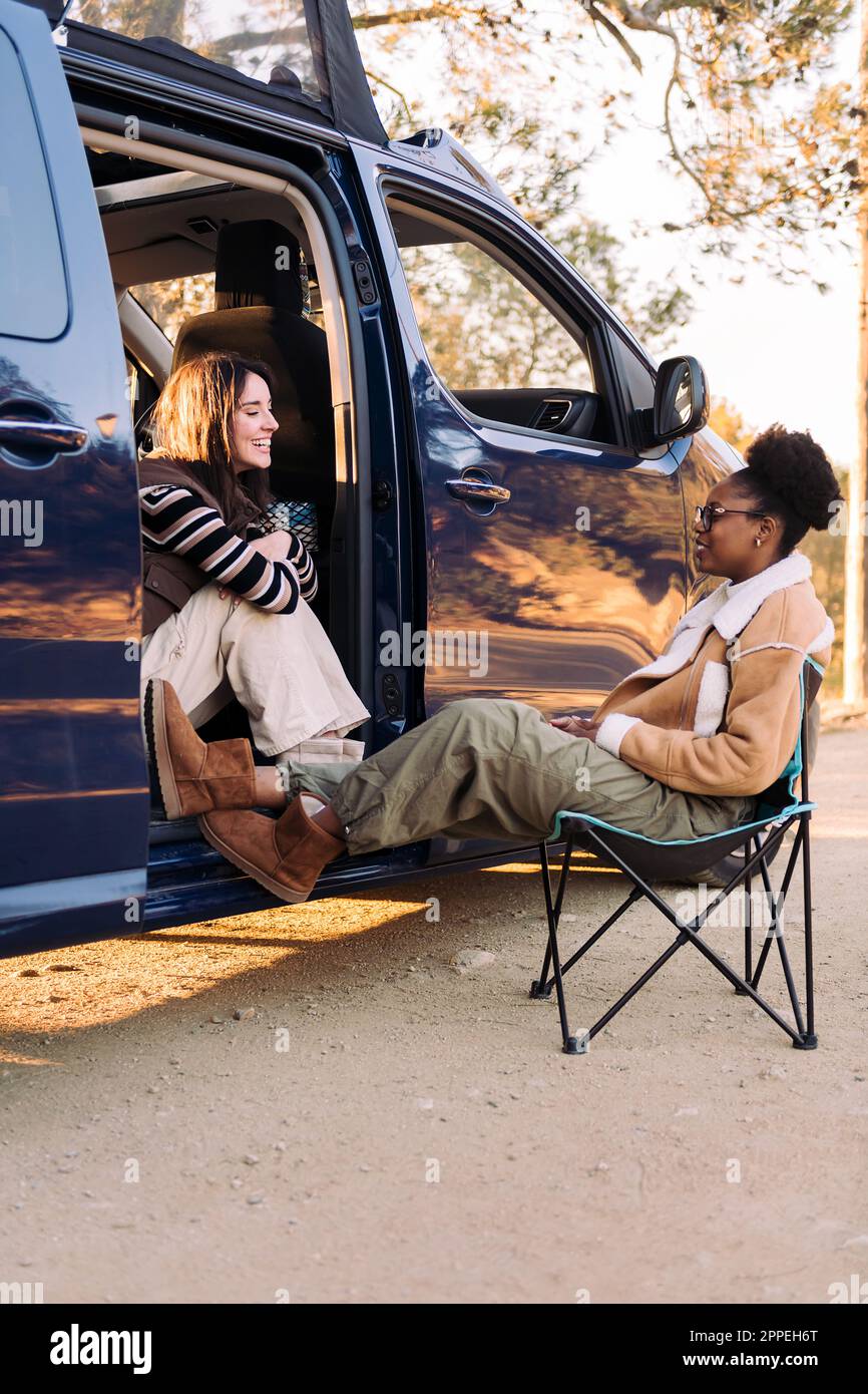 two young friends chatting happy in camper van Stock Photo - Alamy