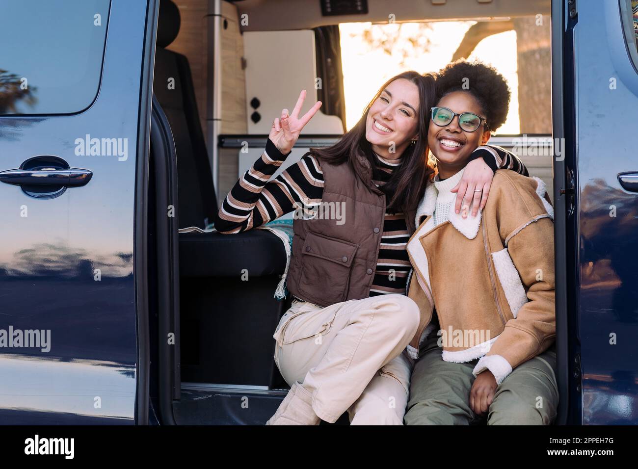 two women in a camper van having fun and smiling Stock Photo - Alamy