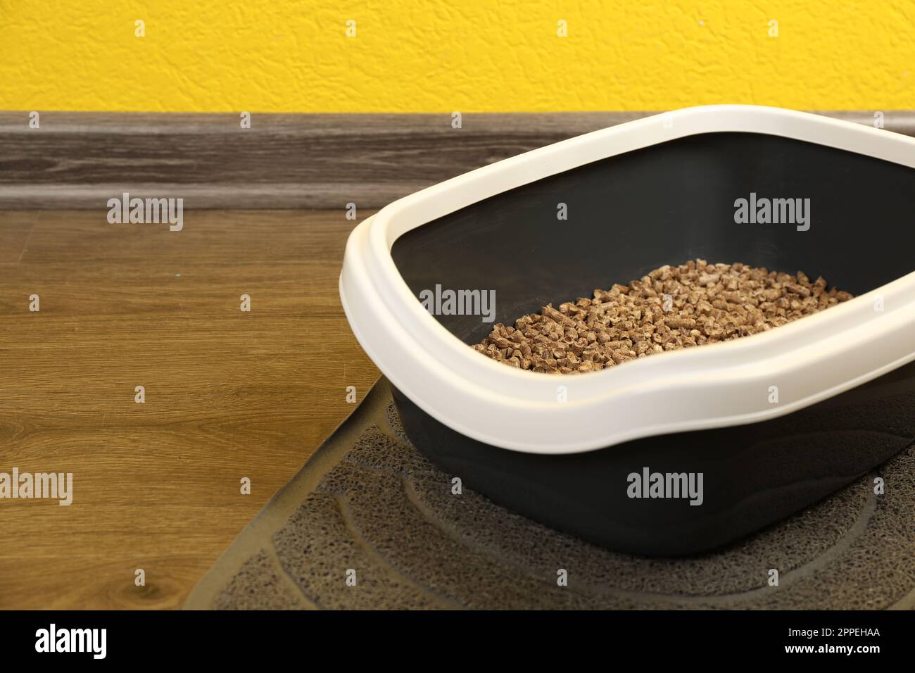 Cat tray with biodegradable litter on floor. Space for text Stock Photo ...
