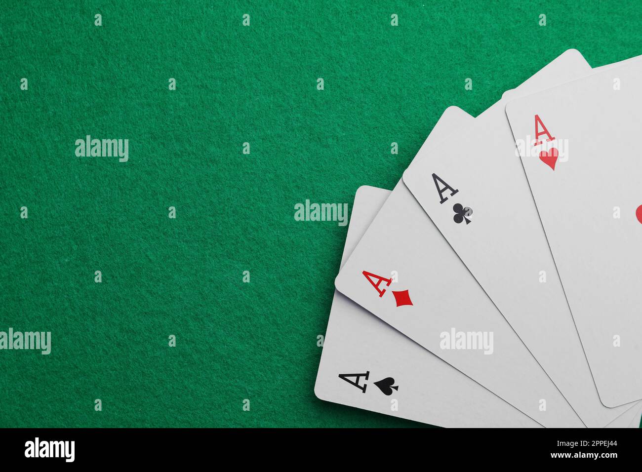 Four aces playing cards on green table, top view. Space for text Stock ...