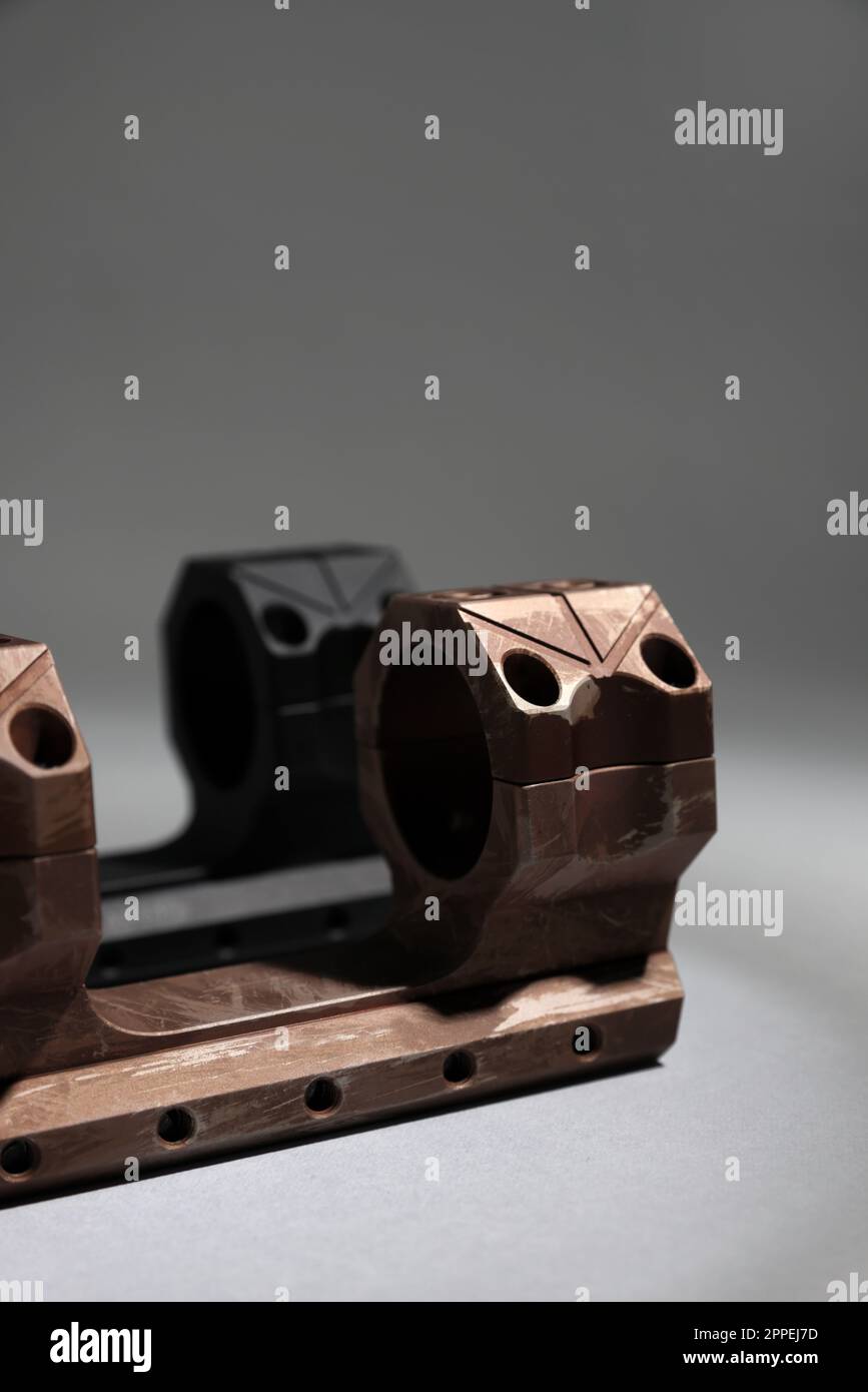 Quick disconnect sniper cantilever scope mounts on grey table, closeup ...