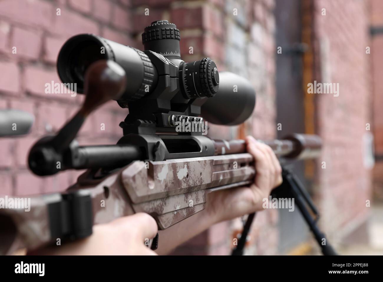 Soldier holding modern powerful sniper rifle with telescopic sight ...