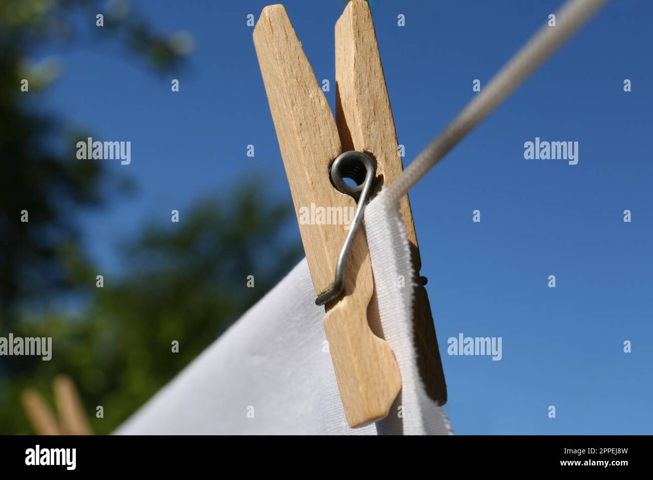 Washing line with clean laundry and clothespin outdoors, closeup Stock ...