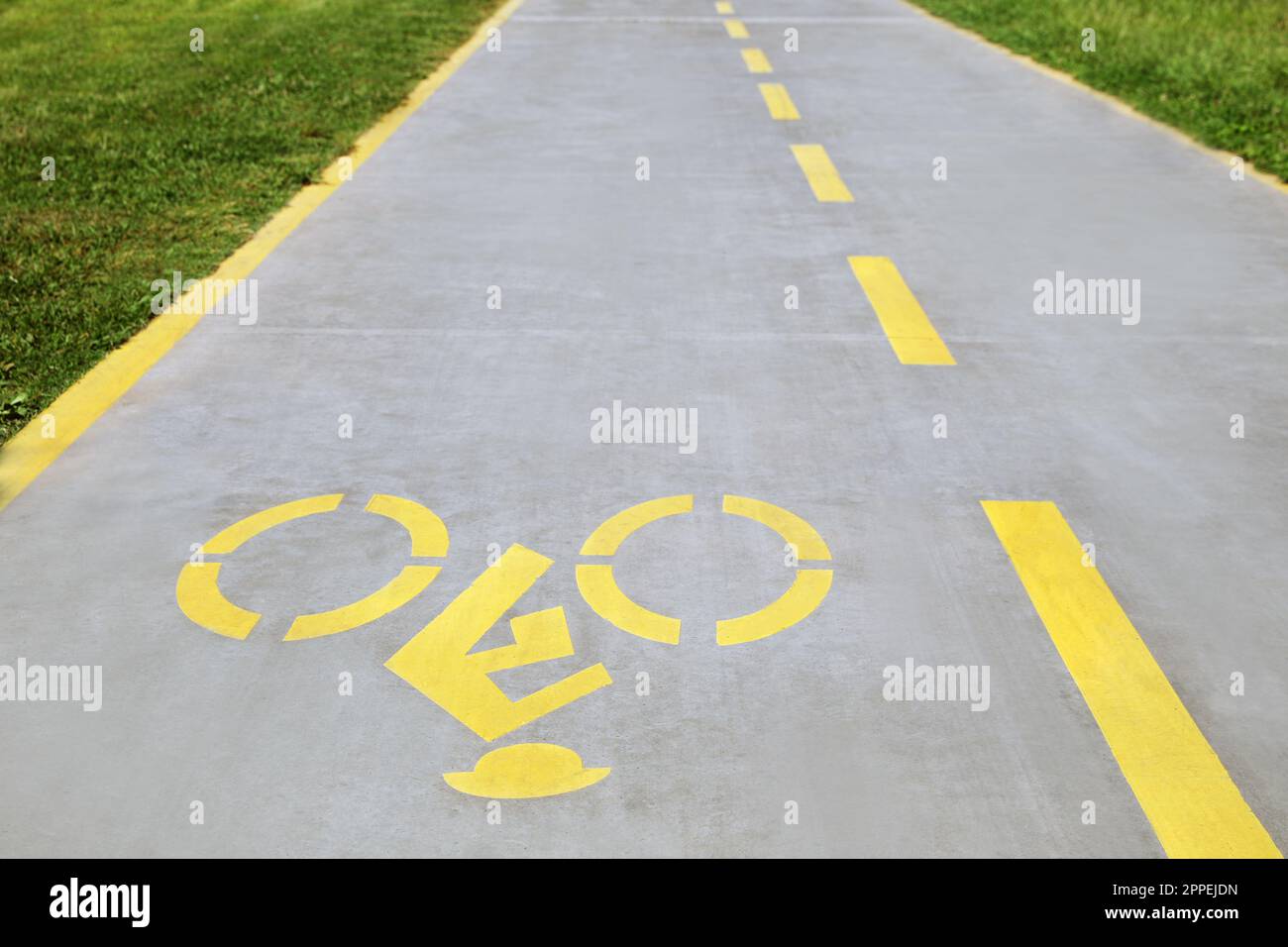 Bike lane with painted yellow bicycle sign Stock Photo - Alamy
