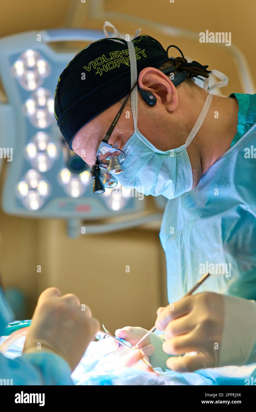 plastic surgeon operates on a patient in the operating room Stock Photo ...