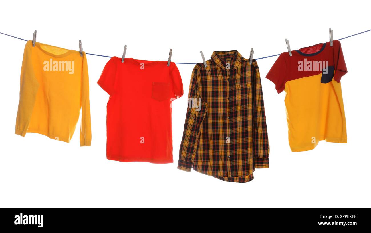 Different bright clothes drying on washing line against white ...