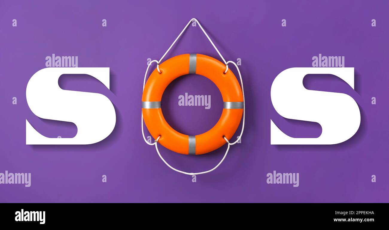 SOS message made from lifebuoy and white letters on violet background ...
