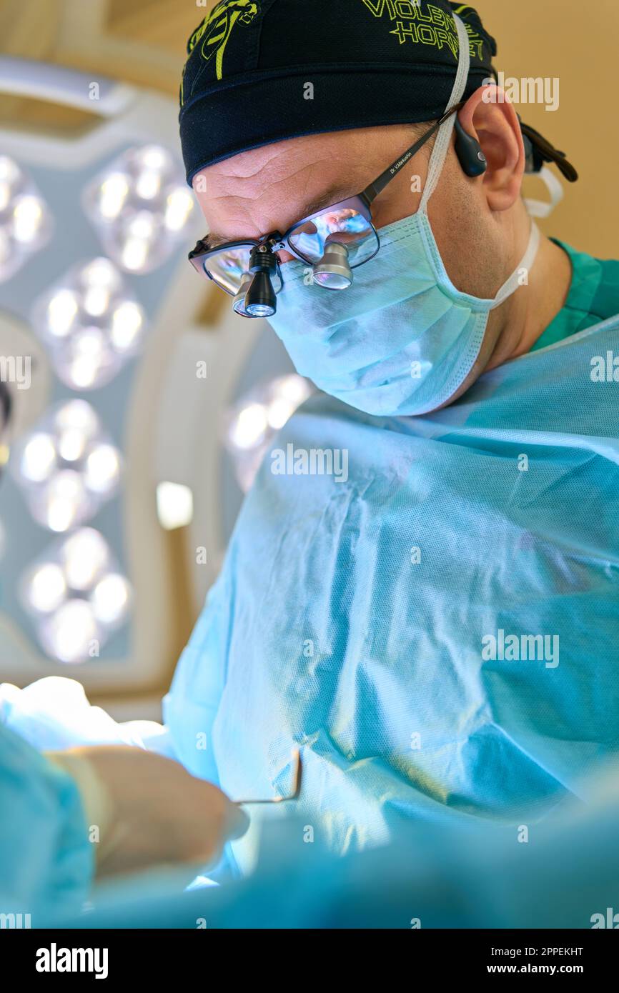 plastic surgeon operates on a patient in the operating room Stock Photo ...