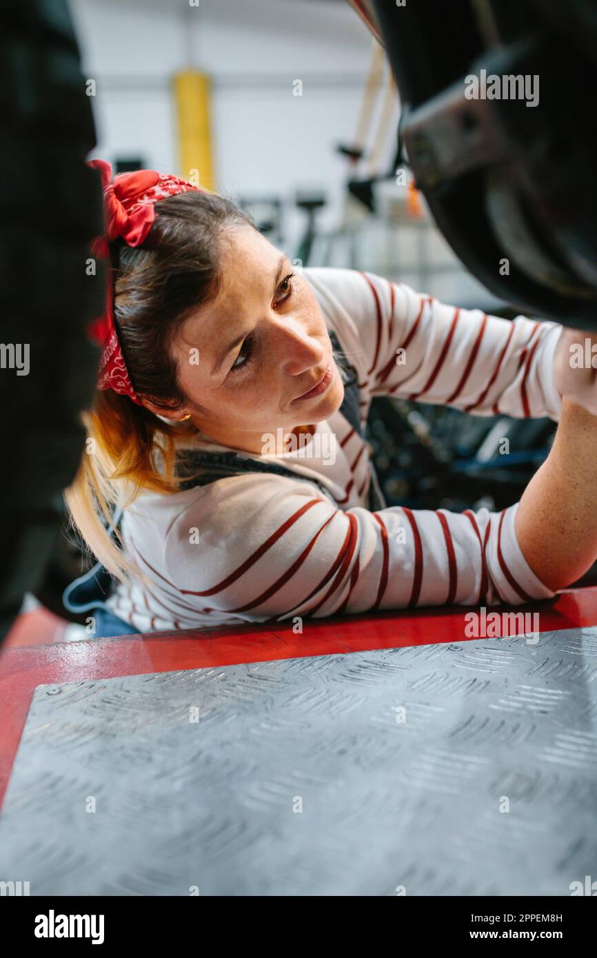 Mechanic woman checking motorcycle on factory Stock Photo - Alamy
