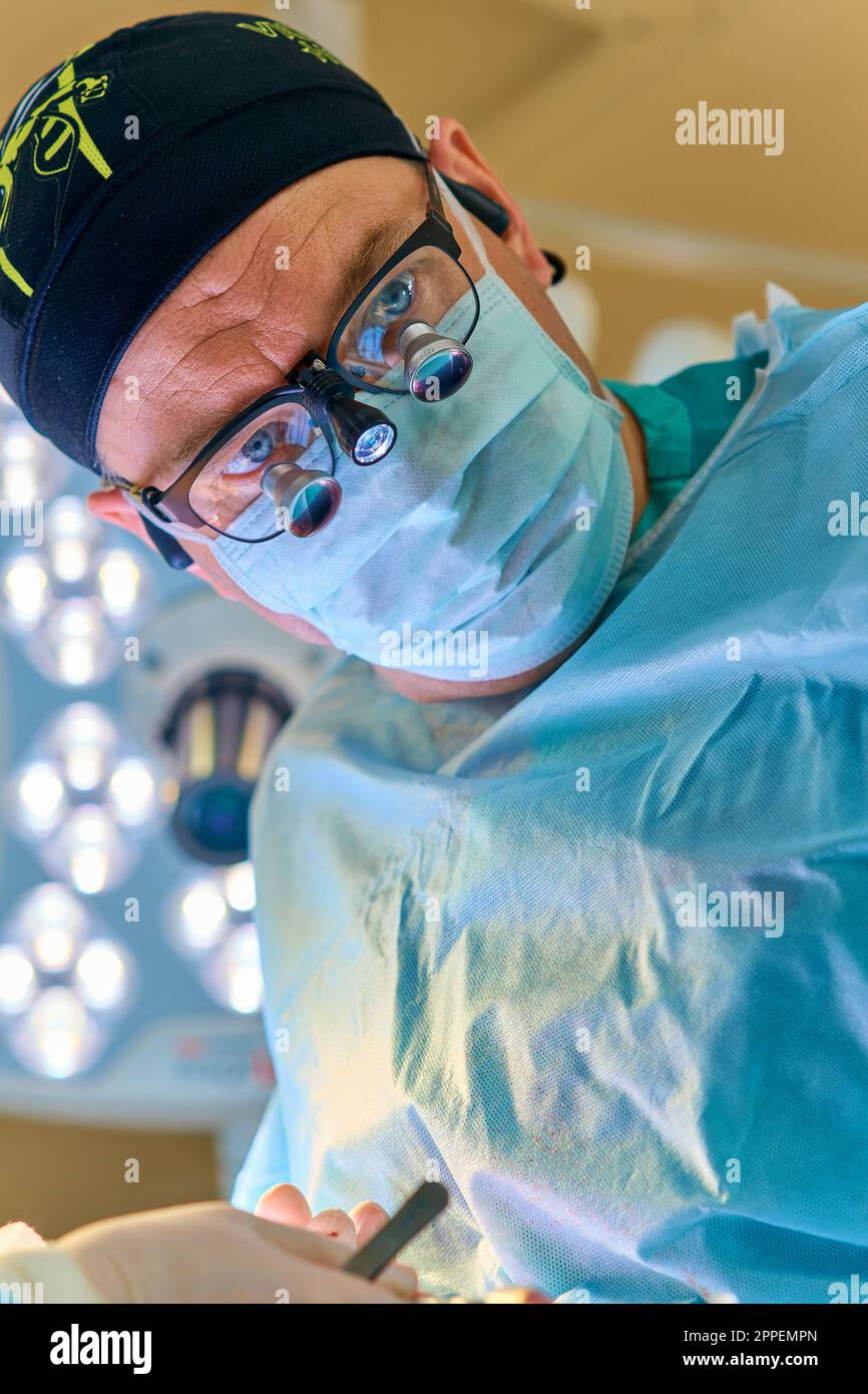 plastic surgeon operates on a patient in the operating room Stock Photo ...