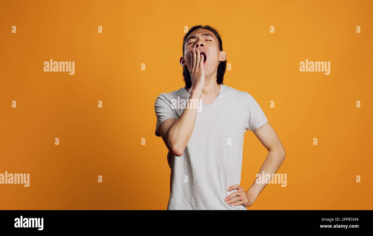 Drained person yawning and being tired in studio, falling asleep and ...