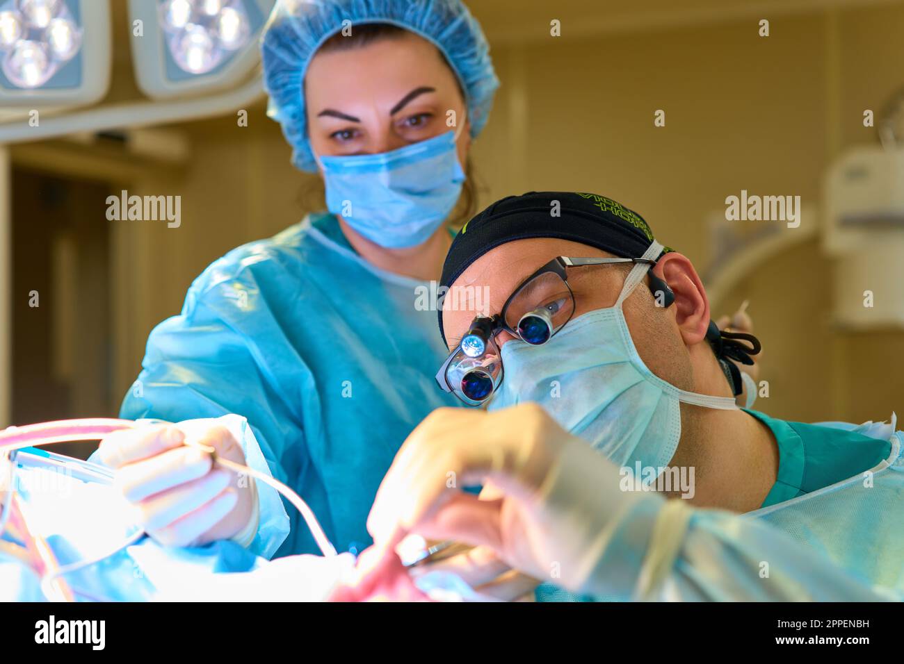 plastic surgeon operates on a patient in the operating room Stock Photo ...